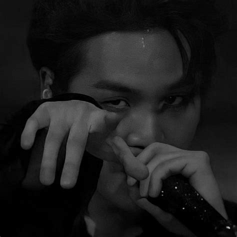 Black And White Photograph Of A Person Holding A Microphone
