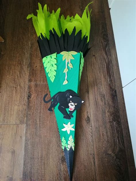 An Upside Down Umbrella On The Floor With Green Leaves And Black
