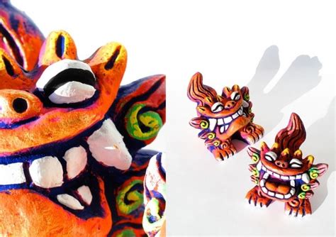 Two Colorful Dragon Figurines Next To Each Other On A White Surface