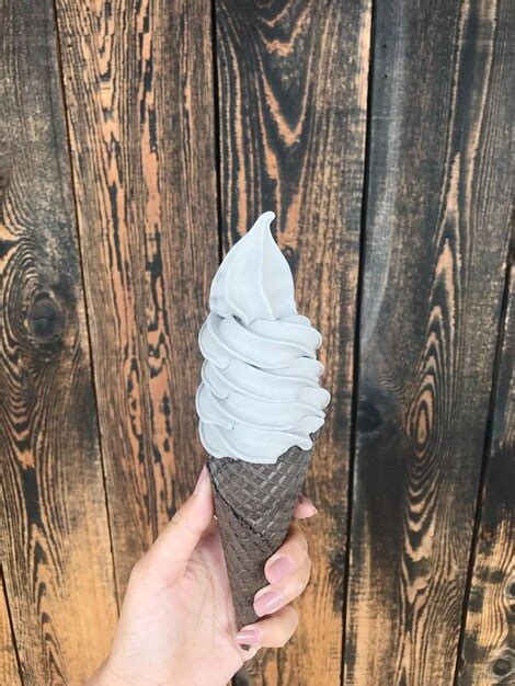 Premium Photo Cropped Hand Of Person Holding Ice Cream