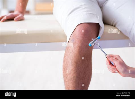 Doctor Checking Nerve Reflexes With Hammer Stock Photo Alamy