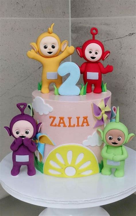 A Three Tiered Cake Decorated With Cartoon Figures And The Number Two