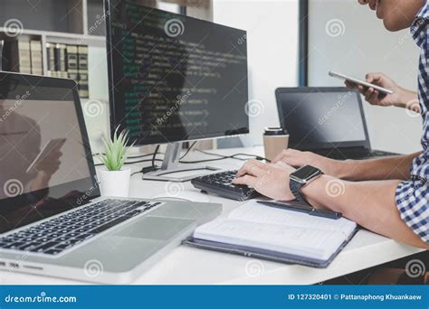 programmers cooperating at developing programming and website working in a software develop