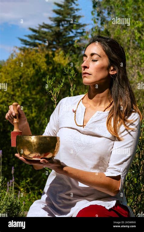Woman Playing A Tibetan Singing Bowl Outdoors Sound Therapy