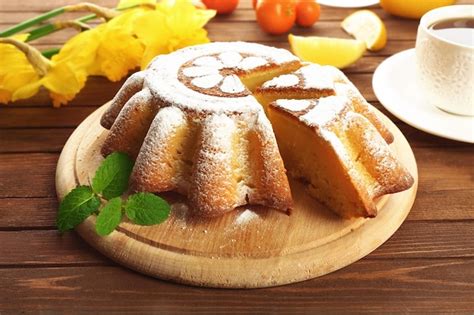 Premium Photo Delicious Citrus Cake With Cup Of Coffee On Wooden Table