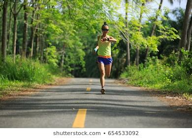 Female Runner Running Summer Park Trail Shutterstock