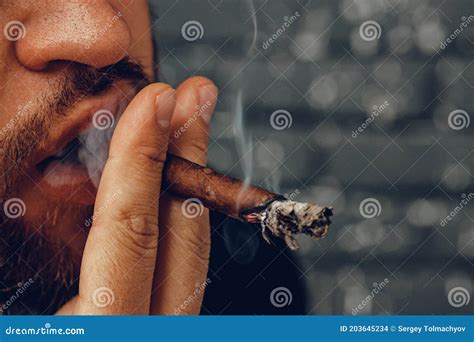 Bearded Man Smoking Cigar Against Black Brick Wall Stock Photo Image
