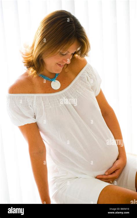 Portrait Of Pregnant Woman Looking At Her Belly Stock Photo Alamy