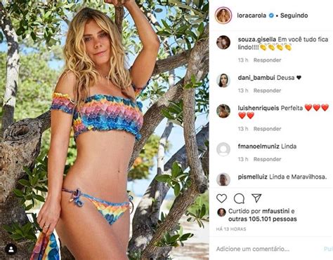 Carolina Dieckmann ostenta barriga sarada ao surgir de biquíni