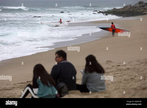 People Watch Surfers Practice One Day Before The Pan American Games Men