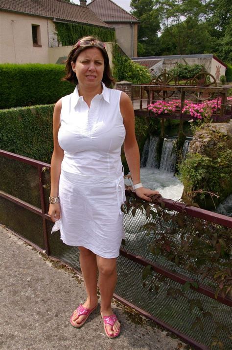 Elegant Woman In White Dress By The River
