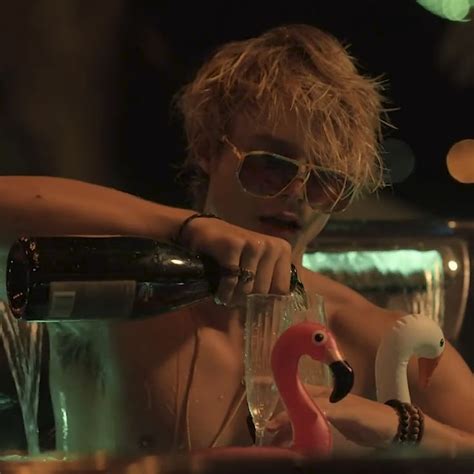 A Shirtless Man Holding A Wine Bottle Next To A Flamingo