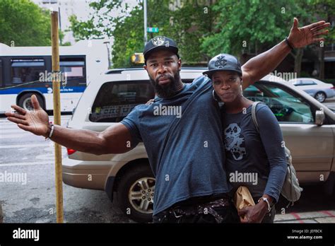 A Black Couple Posing Gangsta Style At The Camera In The Streets Of New
