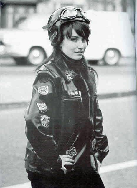 Black And White Photograph Of A Woman Wearing A Motorcycle Helmet With
