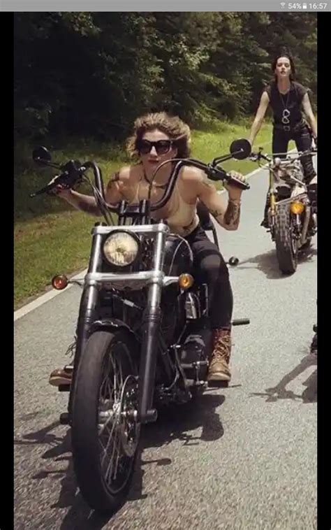 Two People Riding Motorcycles Down The Road With One Person On It S