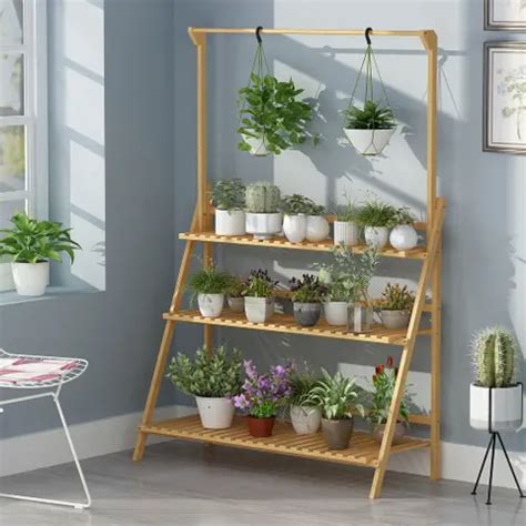 A Shelf Filled With Potted Plants Next To A Window