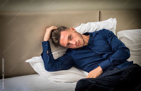 Sexy Male Model Laying Alone On Bed In His Bedroom Looking At Camera With A Seductive Attitude