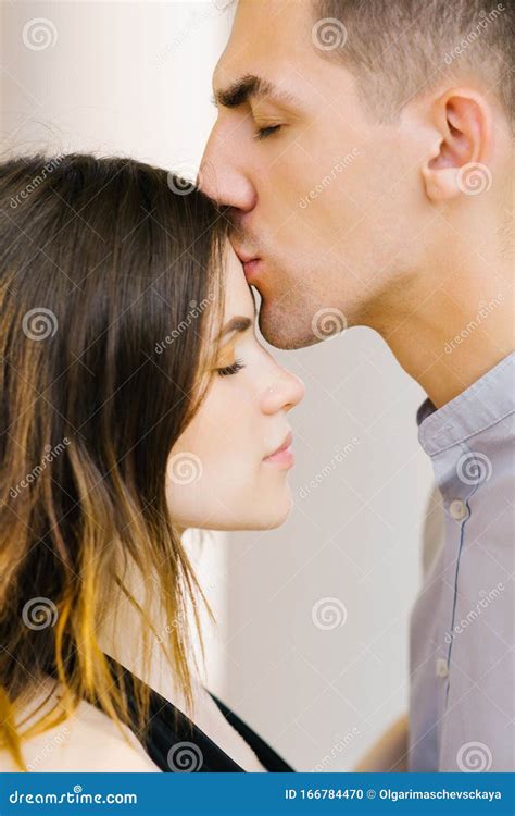 The Guy Kisses The Girl On The Forehead Stock Photo Image Of Intimate