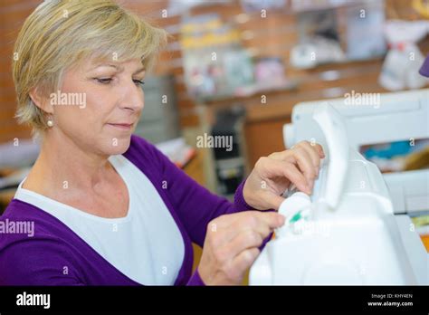 Old Lady In Store Choosing Washing Machine Stock Photo Alamy