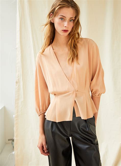 This Is A Peplum Style Blouse With A Plunging V Neckline And Voluminous