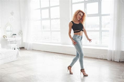 Walking To The Side Attractive Redhead Woman Posing In The Spacey Room Near The Window 8681676