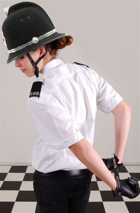 A Woman Wearing A White Shirt And Black Pants With A Motorcycle Helmet