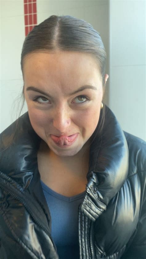 A Woman Sticking Her Tongue Out And Making A Funny Face While Wearing A