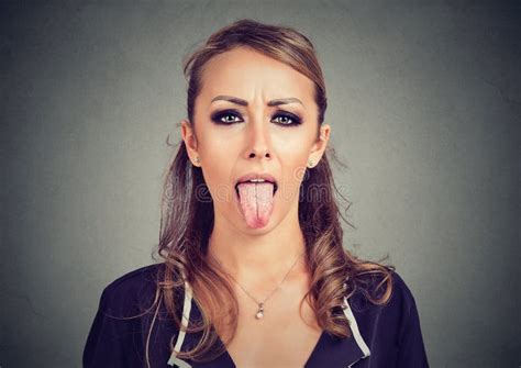 Closeup Portrait Of A Woman Sticking Her Tongue Out Stock Photo Image