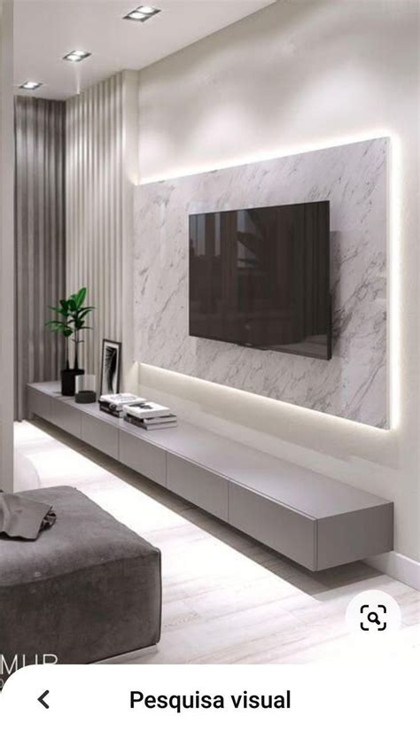 A Living Room Filled With Furniture And A Flat Screen Tv Mounted To The