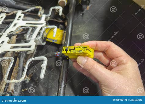 Repairing Automotive Electrical Wiring An Auto Electrician Holds A
