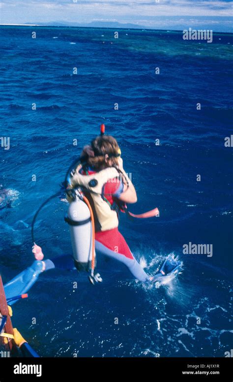 Scuba Diver Jumping Into Sea Stock Photo Alamy