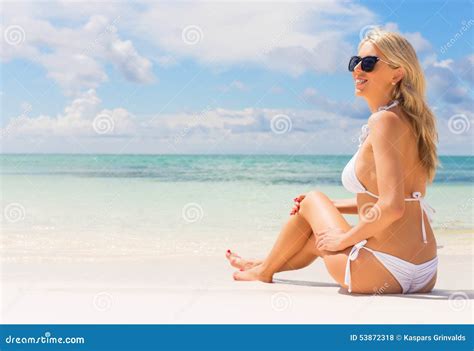 Beautiful Woman In White Bikini Sitting On The Beach Stock Photo