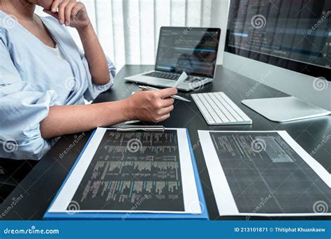 female programmer working in software javascript computer in it office writing codes and data