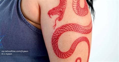 Large Red Snake Tattoo Located On The Upper Arm
