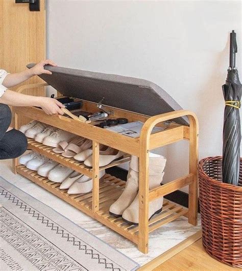 A Woman Kneeling Down Next To A Wooden Shoe Rack