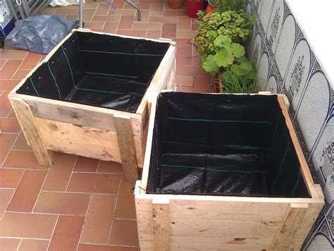 Two Wooden Planters Sitting Next To Each Other On A Brick Floor With