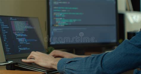 closeup coding on screen man hands coding html and programming on screen laptop development
