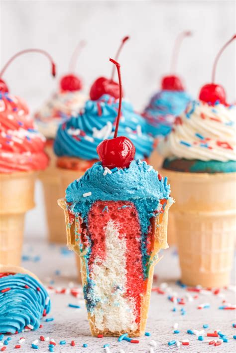 Cupcakes With Blue Red And White Frosting On Them Are Sitting In Ice