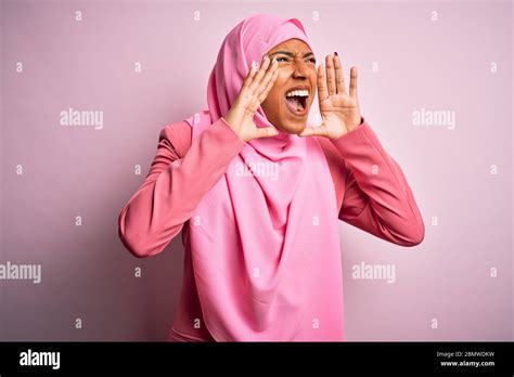 Young African American Afro Woman Wearing Muslim Hijab Over Isolated Pink Background Shouting