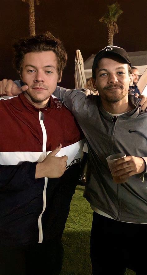 Two Men Are Standing Next To Each Other