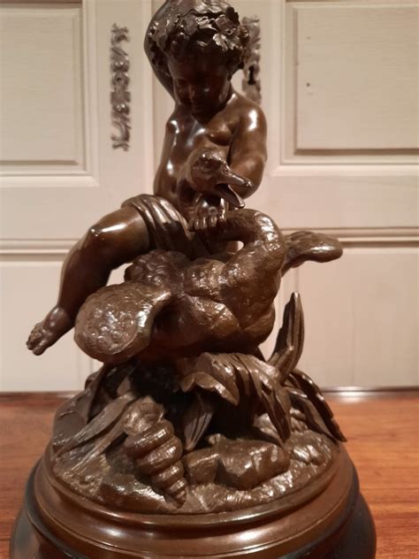 Proantic Th Century Regulates Sculpture Representing A Putti Riding