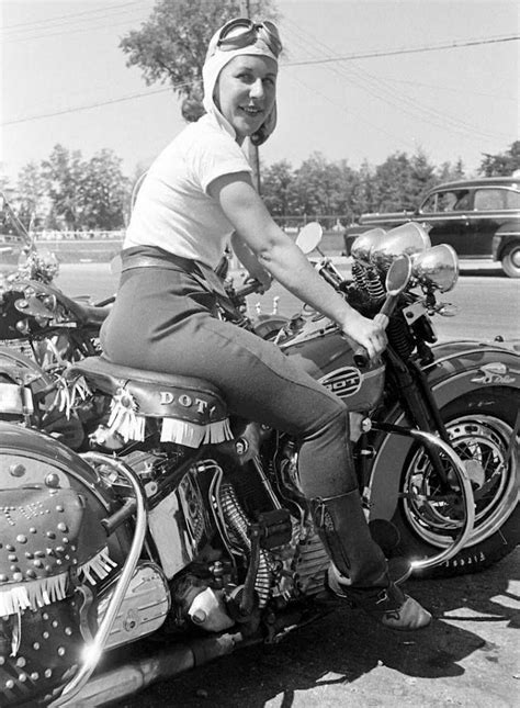 A Woman Sitting On Top Of A Motorcycle With Lots Of Other Motorcycles