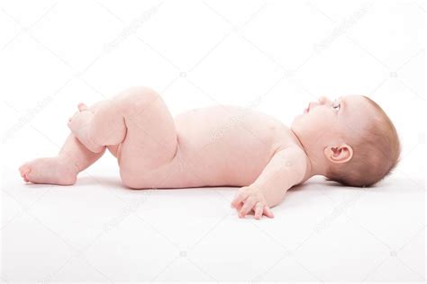 Naked Baby Lies On His Back And Looks At The Camera Stock Photo By