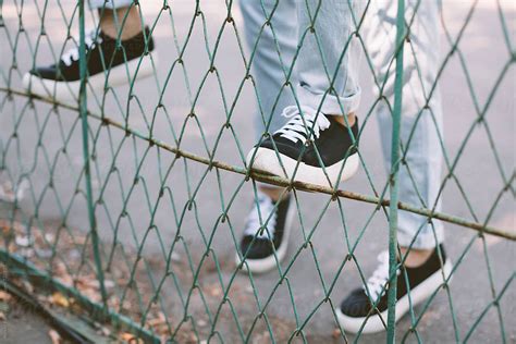 Teen Girls Climbing Over The Fence By Stocksy Contributor Alexey Kuzma Stocksy