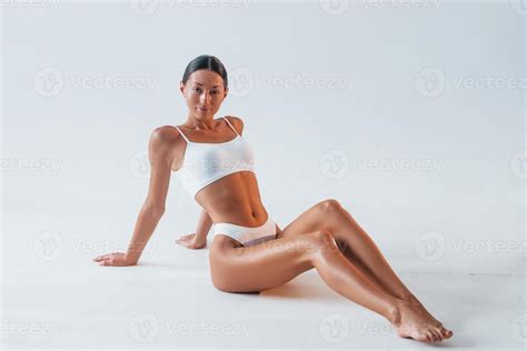 Sitting On The Floor Beautiful Woman With Slim Body In Underwear Is In