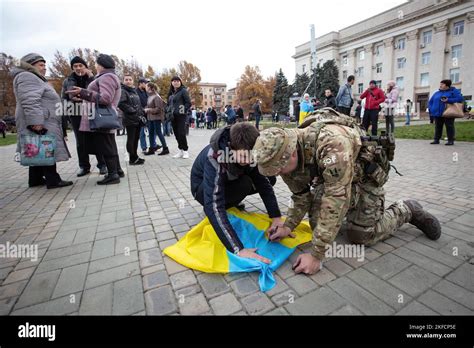 Ein ukrainischer Militärangehöriger gibt einem Bewohner im Zentrum von