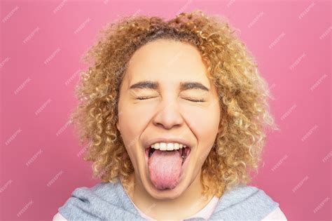 Premium Photo Close Up Of Girls Face She Is Showing Her Big Tongue And Keeping Her Eyes Closed