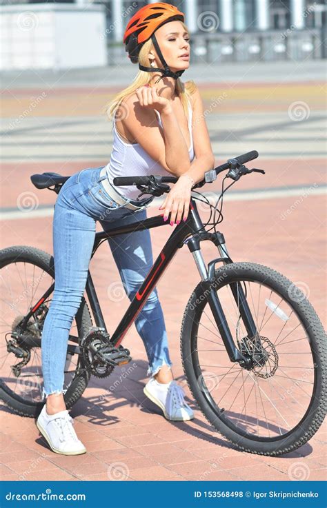 Girl Blonde Girl With Big Tits In Helmet Is Posing Outdoor On The