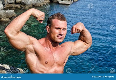 Double Biceps Pose For Young Bodybuilder By The Sea Stock Image Image Of Outdoor Adult 32222057