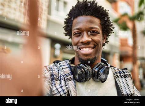 Handsome Black Man With Afro Hair Wearing Headphones Smiling Happy
